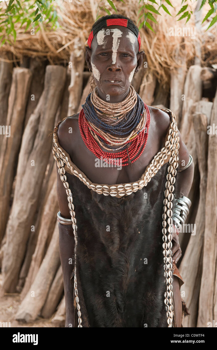 Karo woman withcolorful and cowry shells necklaces and facial paintings ...