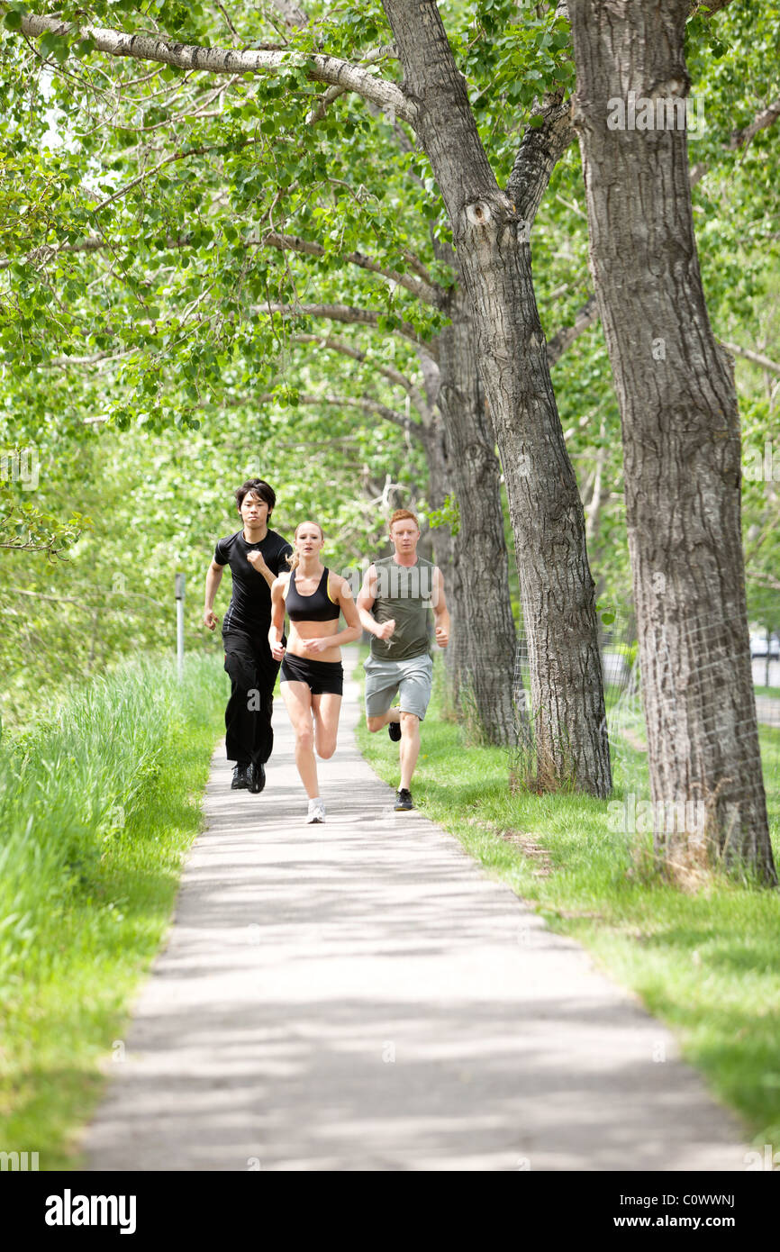 Friends jogging during morning time against blur background Stock Photo ...