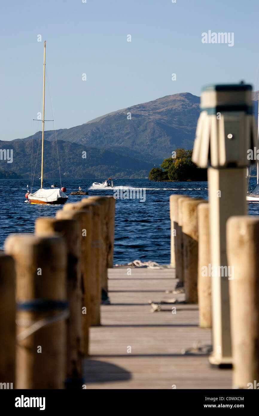 Wooden jetty looking out from Bowness Bay North to the Langdale pikes ...