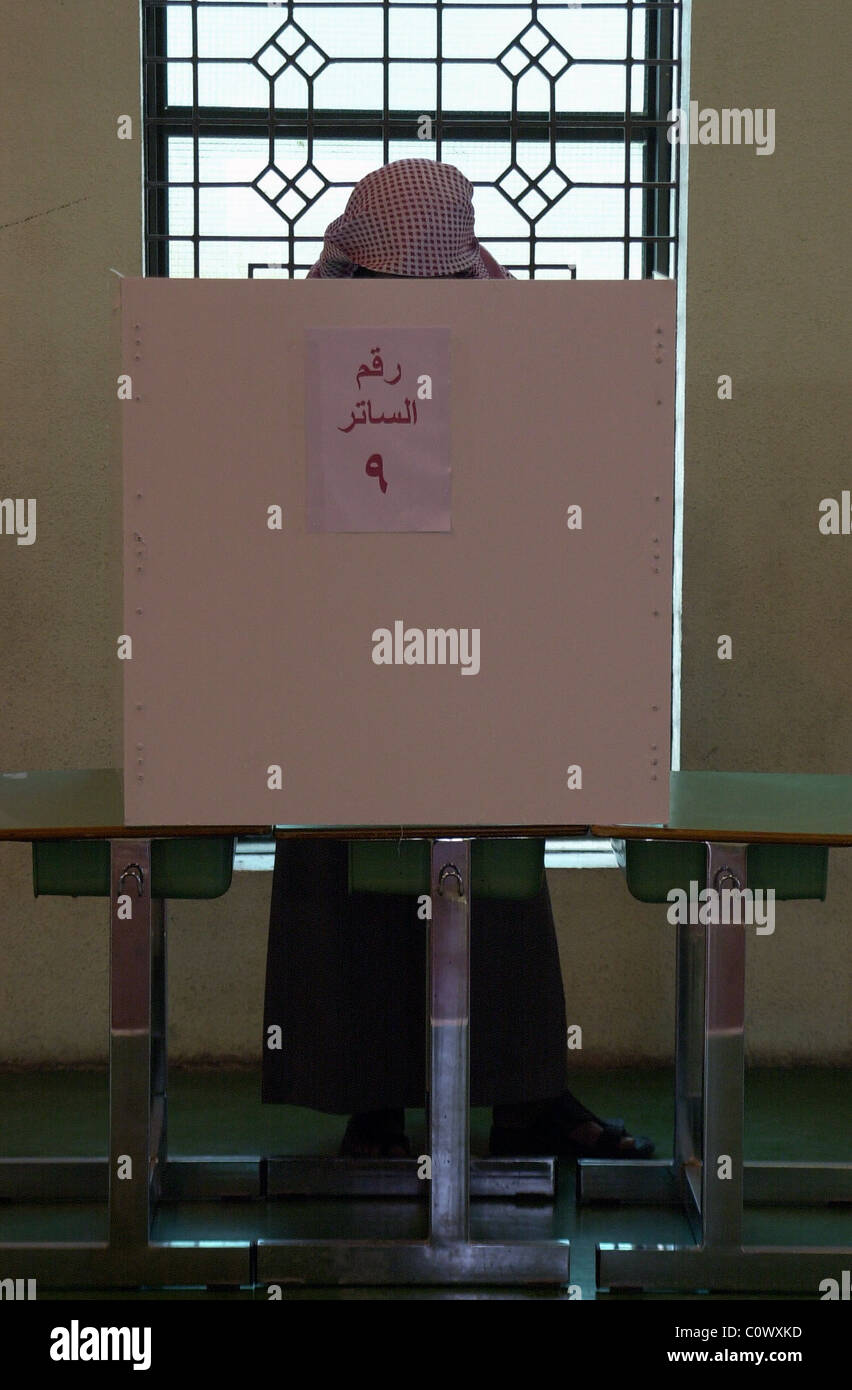 Riyadh, Saudi Arabia -- 10 February 2005 -- A voter behind the booth ...