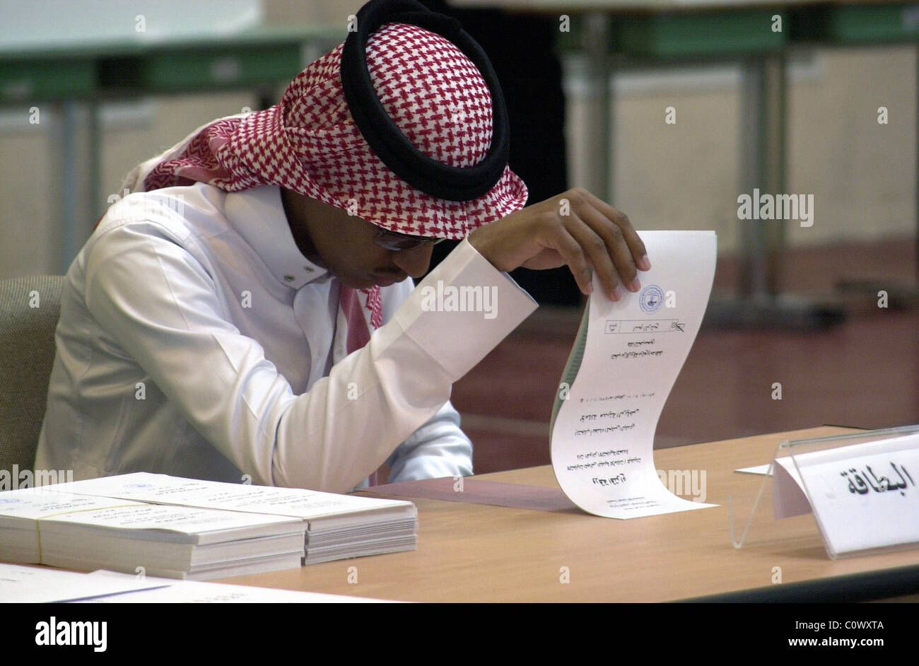 An election official checks ballots during historic first municipal ...