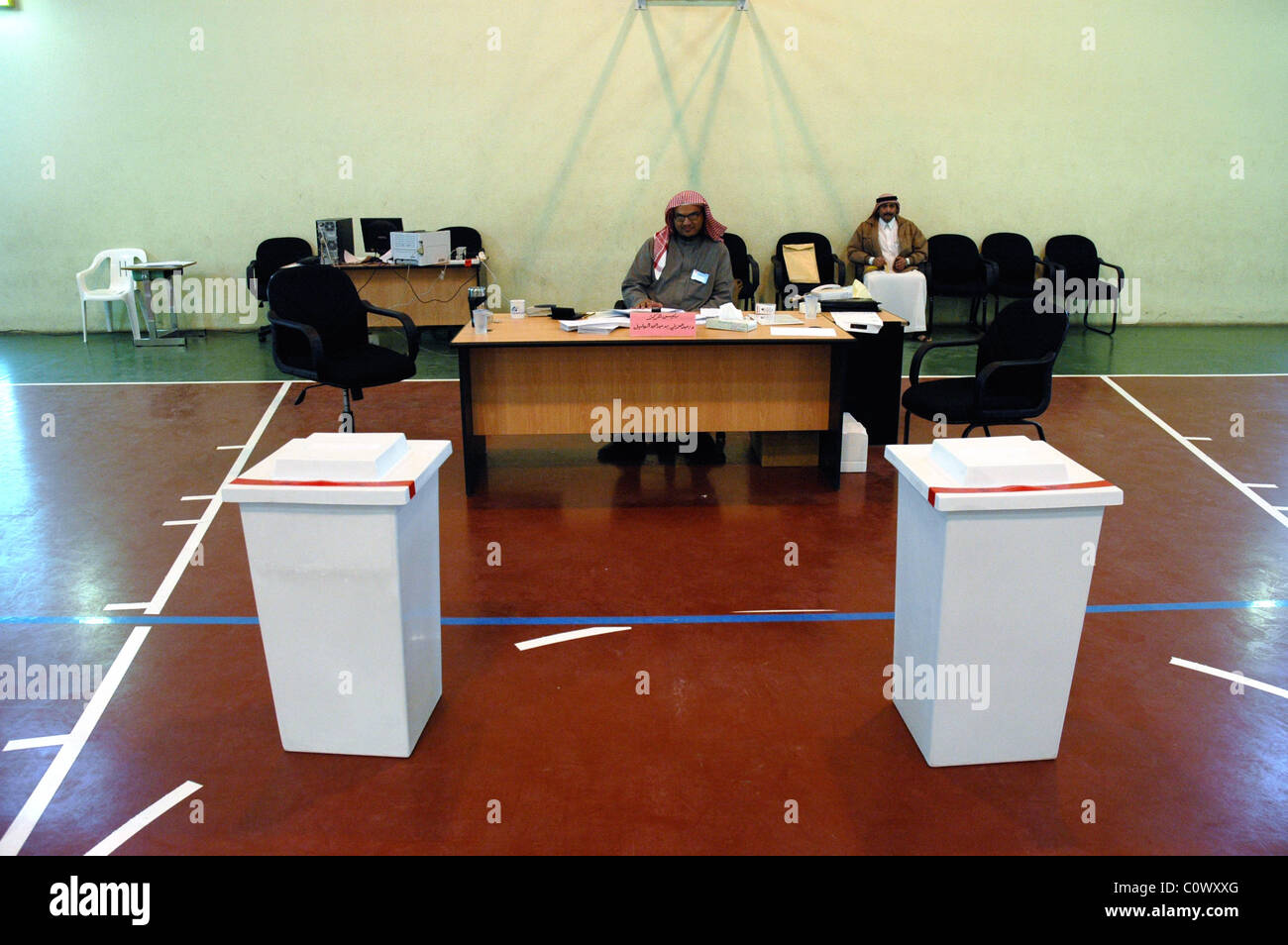 A Saudi election official sits at a desk near the ballot boxes during ...