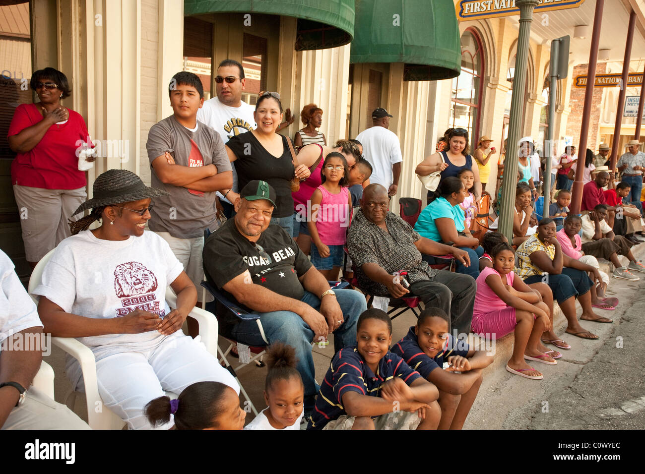African-American crowd wait for floats to pass by during parade ...