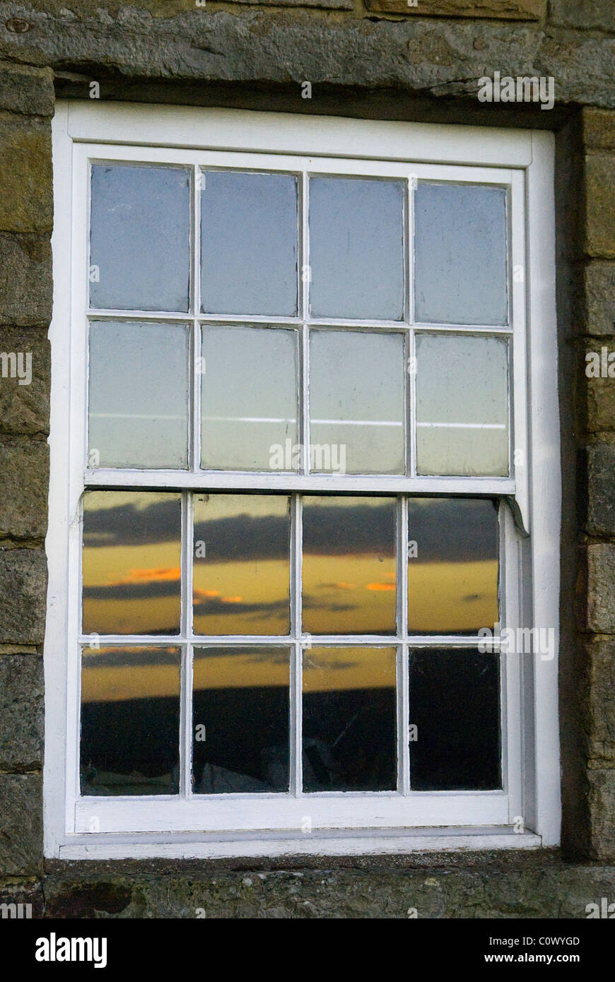Sunset reflected in window Stock Photo - Alamy