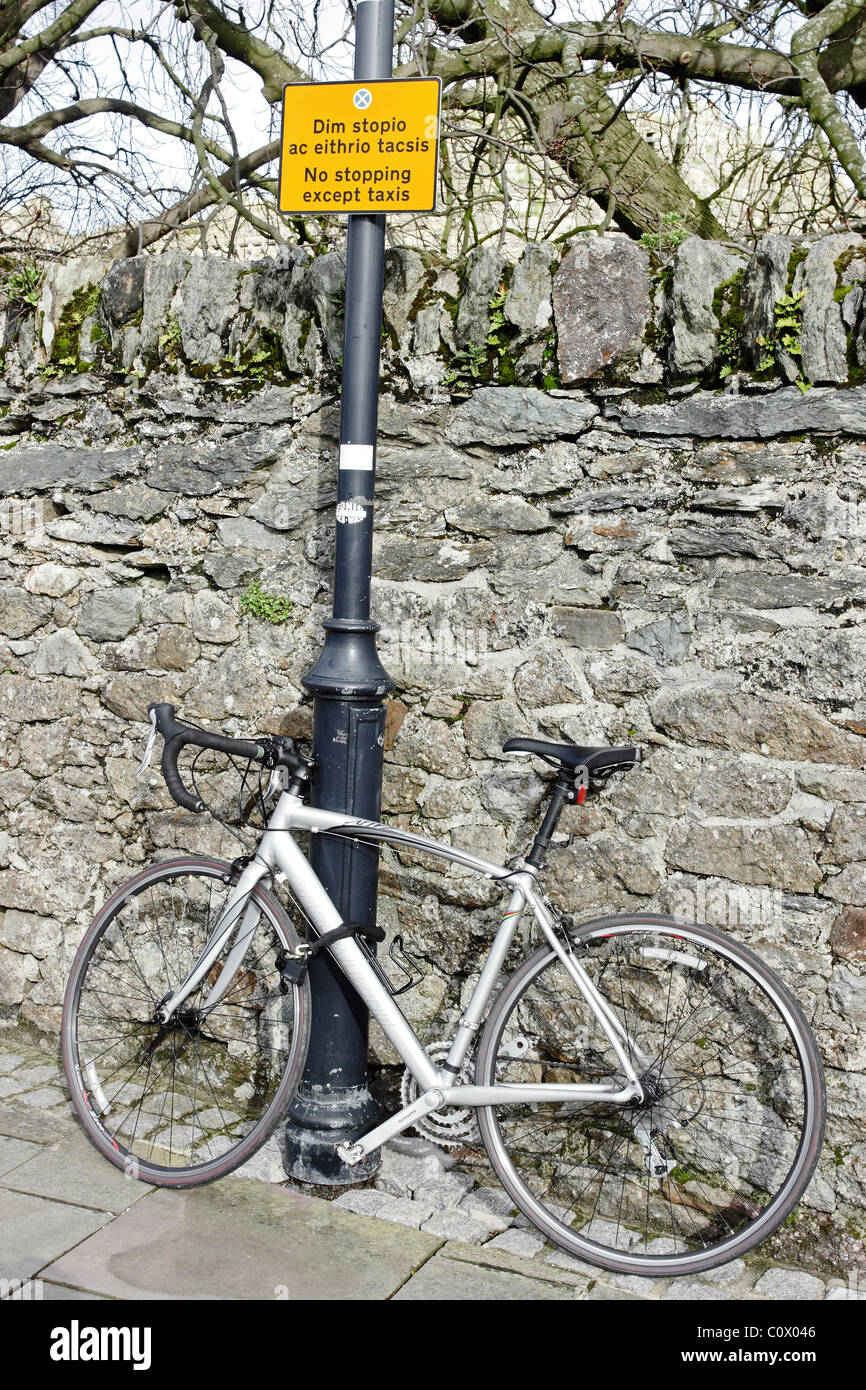 A pedal cycle left under a 'no stopping except taxis' sign Stock Photo ...