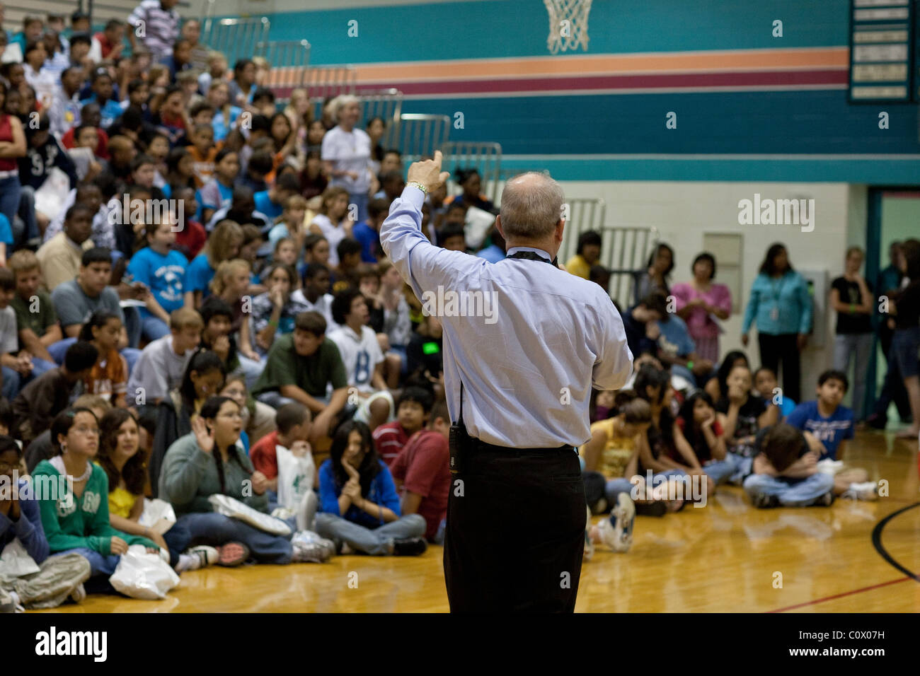 Middle school principal calls for students' attention at beginning of ...