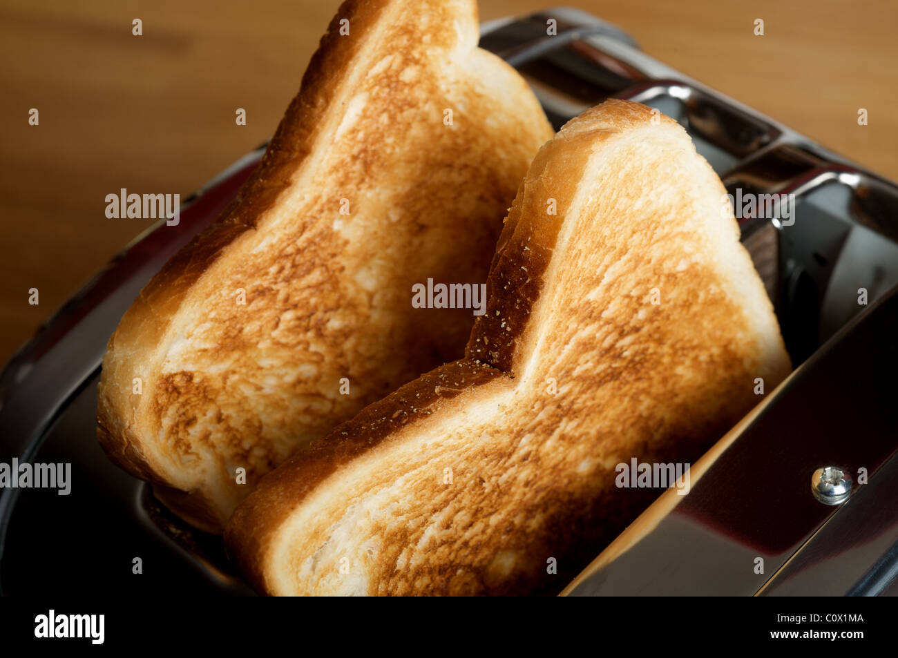 Toast in toaster Stock Photo - Alamy