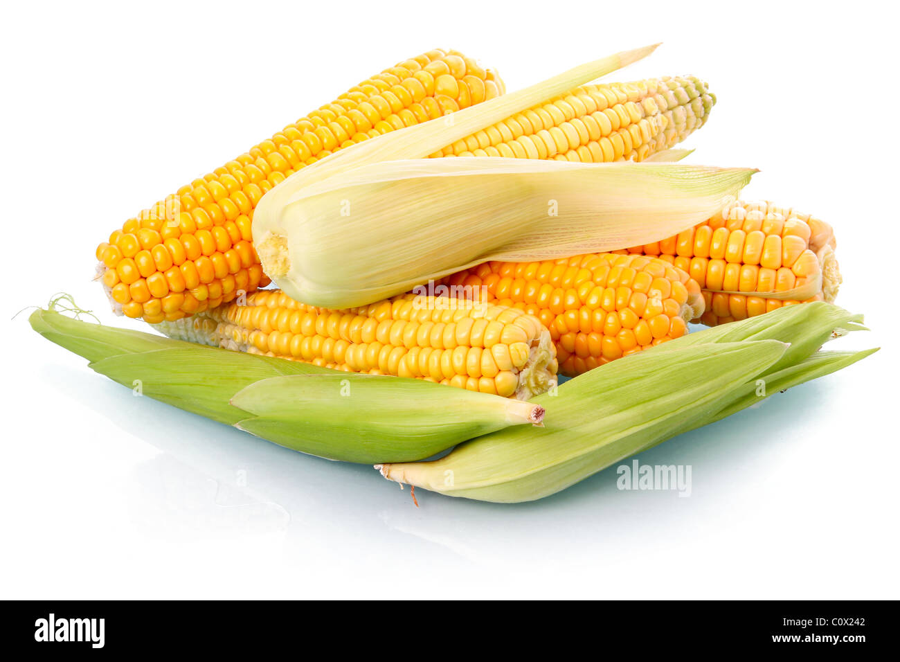 Fresh corn vegetable with green leaves isolated Stock Photo - Alamy