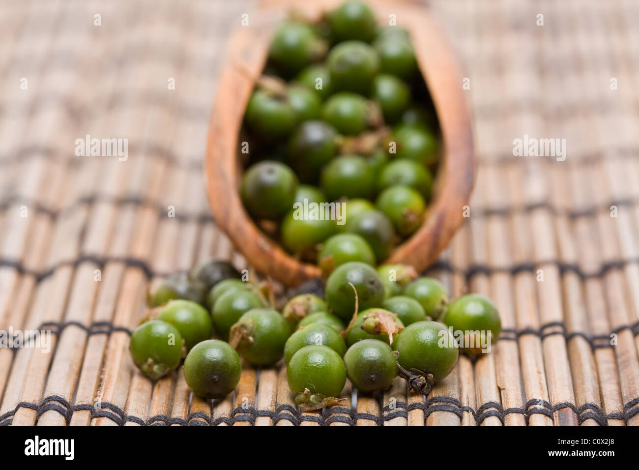 Unprocessed fresh green peppercorns in wooden scoop Stock Photo - Alamy