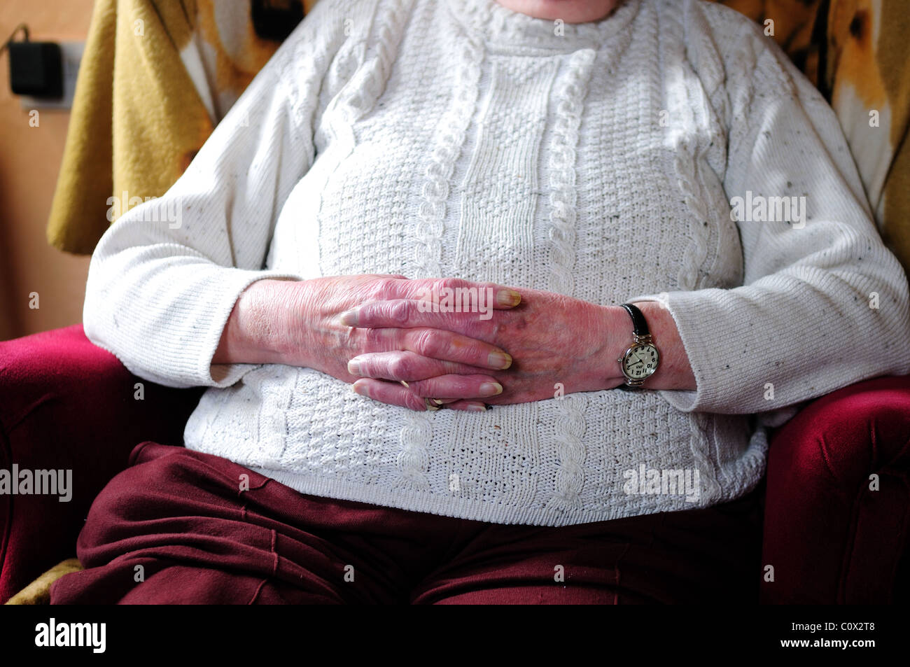 An Elderly Women at Home With Hands Clasped Stock Photo - Alamy