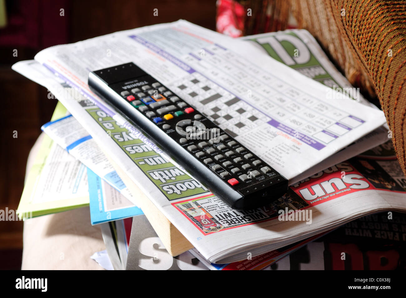 TV Remote Control with Newspaper and Magazines Stock Photo - Alamy