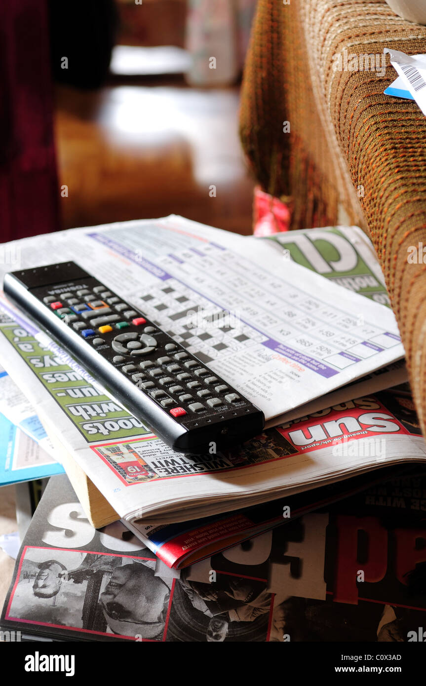 TV Remote Control with Newspaper and Magazines Stock Photo - Alamy