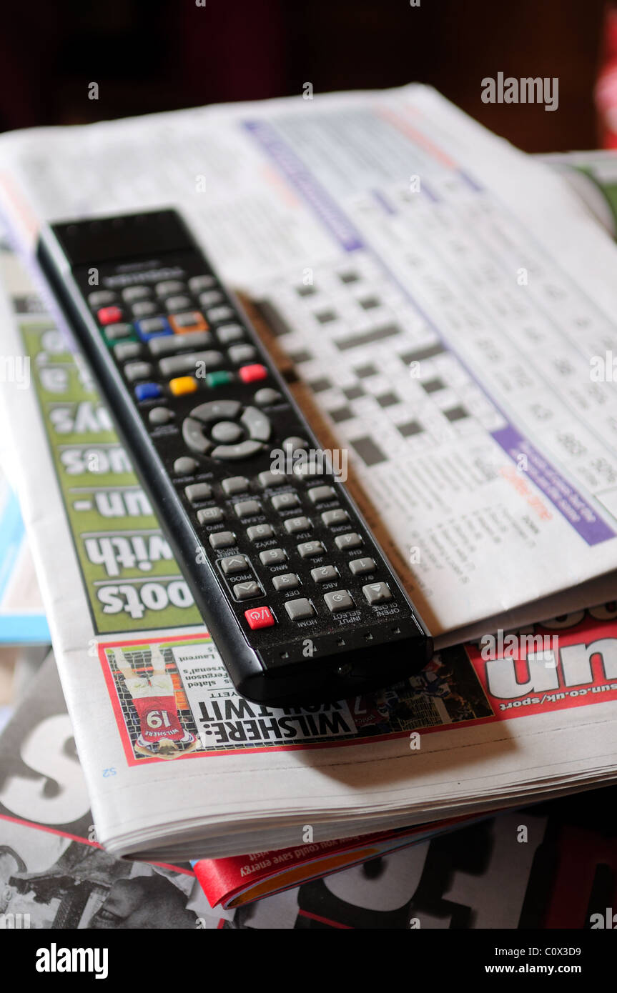 TV Remote Control with Newspaper and Magazines Stock Photo - Alamy