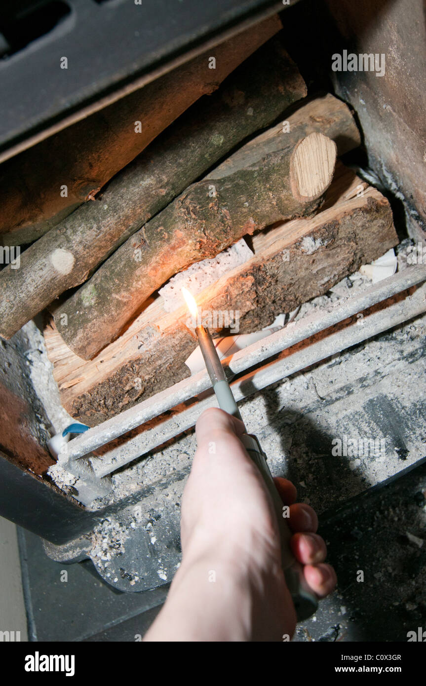 Lighting fire in woodburner Stock Photo - Alamy