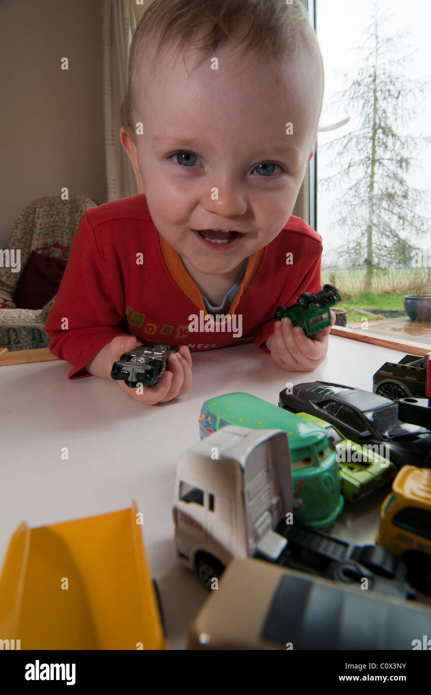 Toddler playing with toy cars Stock Photo - Alamy
