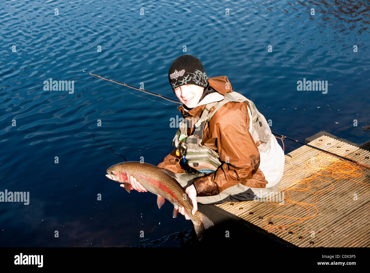 Young angler with a Rainbow Trout (Oncorhynchus Mykiss), England UK ...