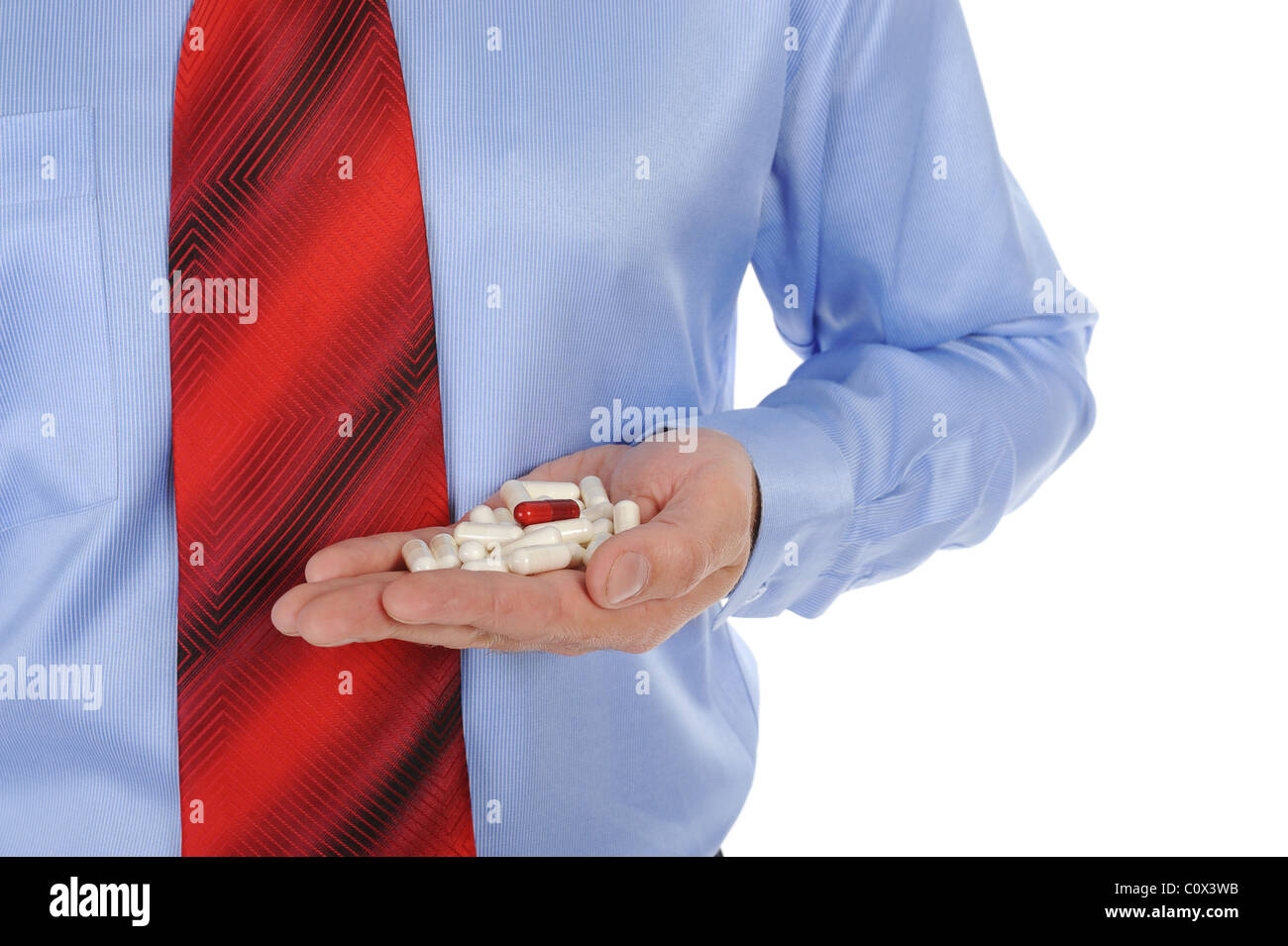 Red and white tablets in male hands Stock Photo - Alamy