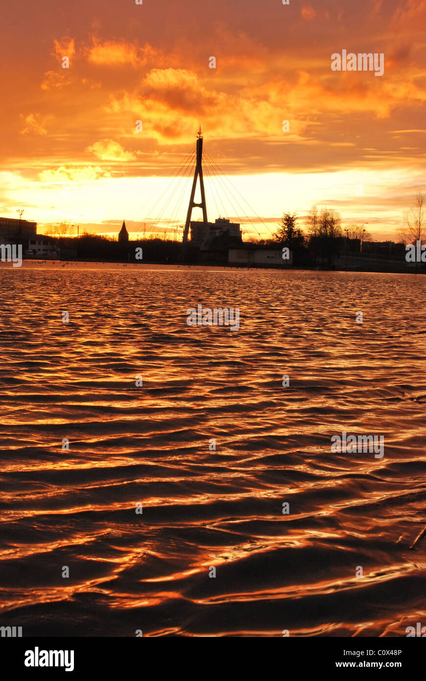 sunset over buildings in city Stock Photo - Alamy