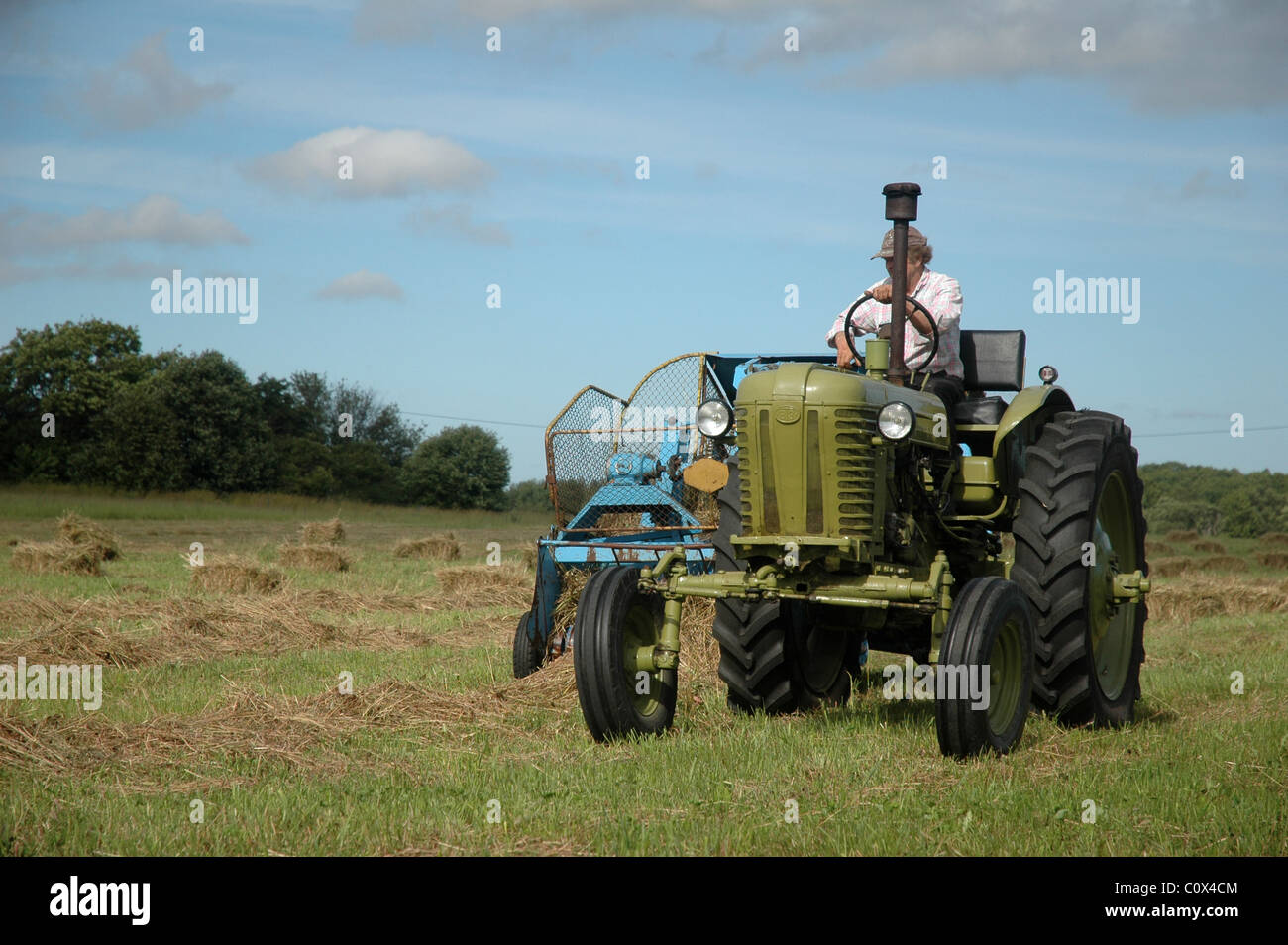 vintage tractor works on field Stock Photo - Alamy