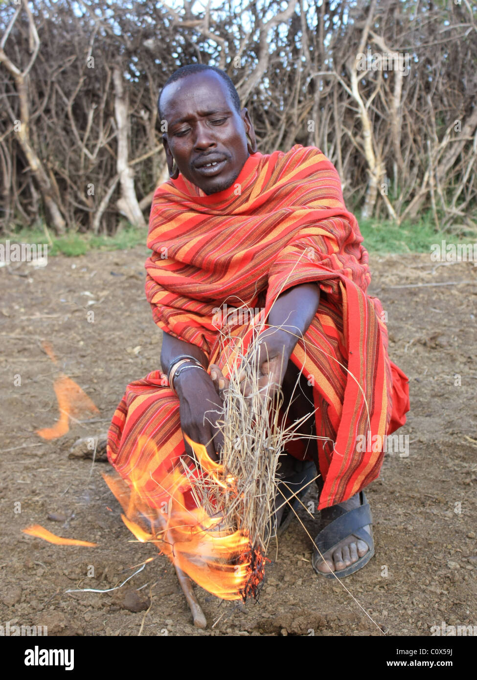 Masai Man setting fire Stock Photo - Alamy