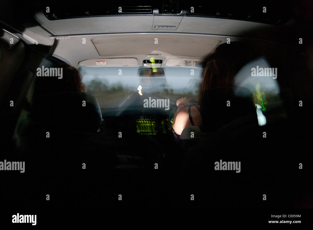 Female driver and companion traveling along roadway Stock Photo - Alamy