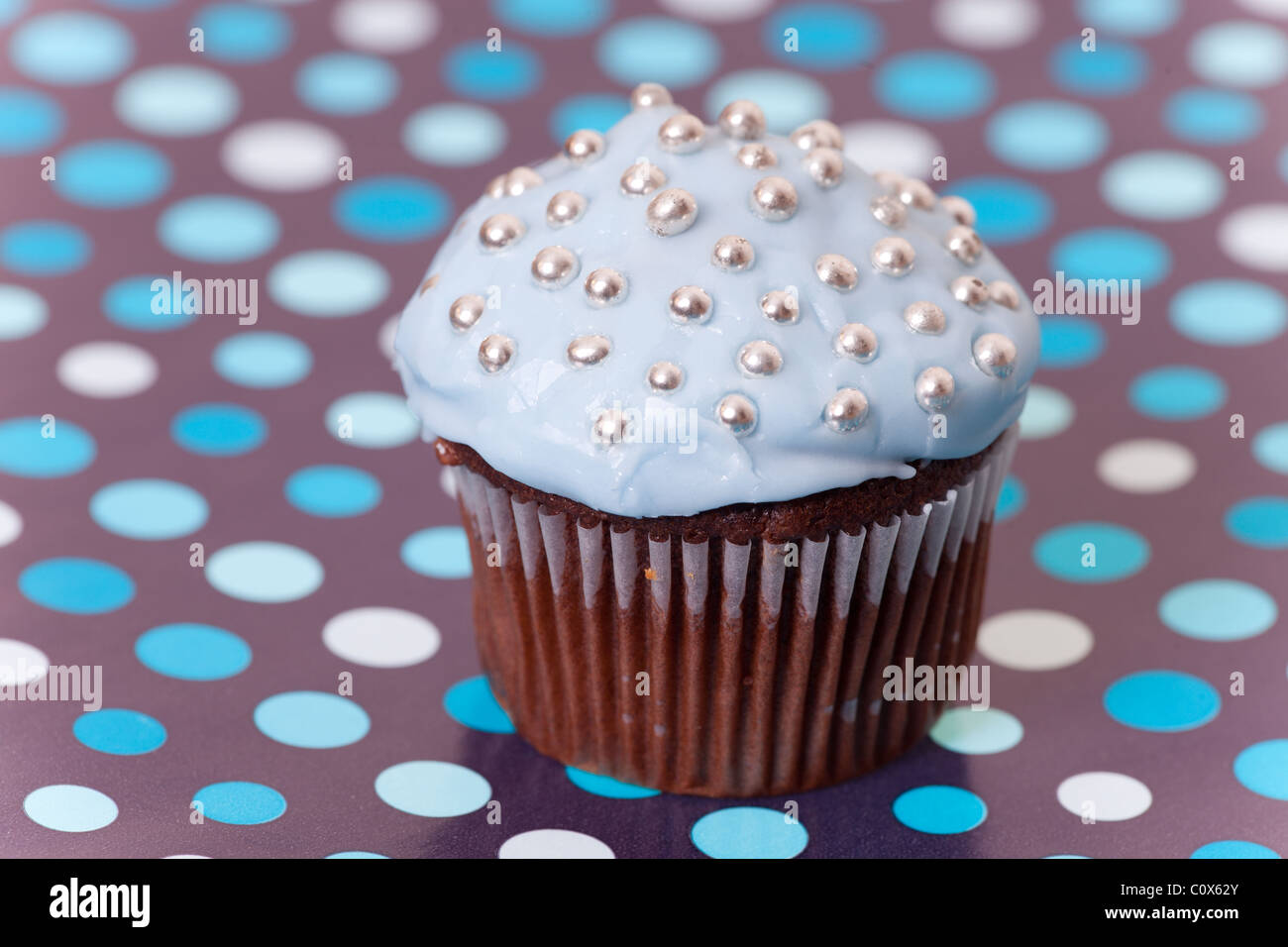 blue cup cake on blue background Stock Photo - Alamy