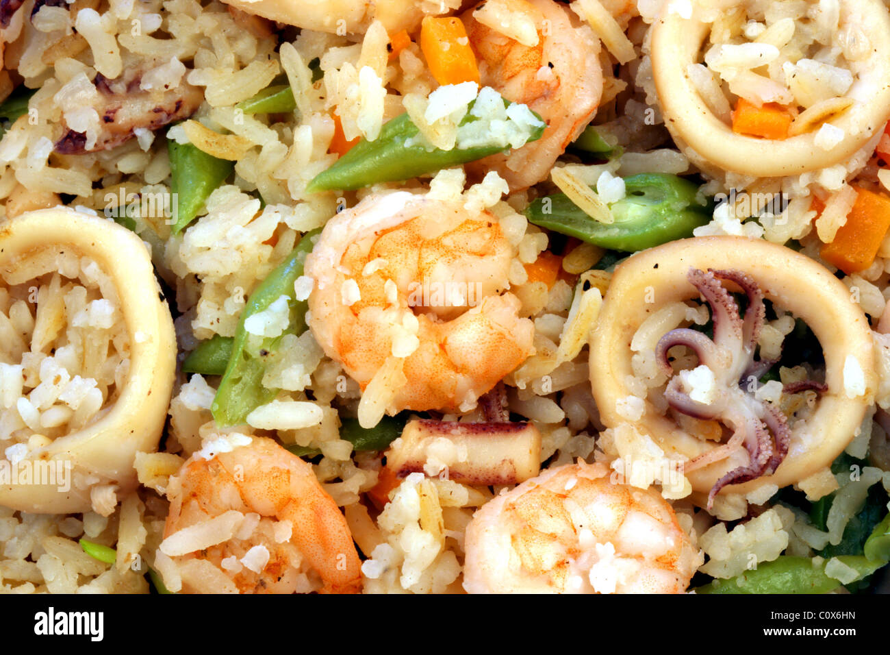 delicious calamari rice with assorted seafood and vegetables served on ...