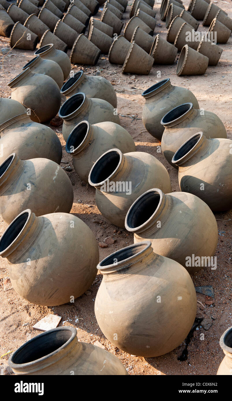 Hand made indian water pots drying in the sun before firing. Andhra ...