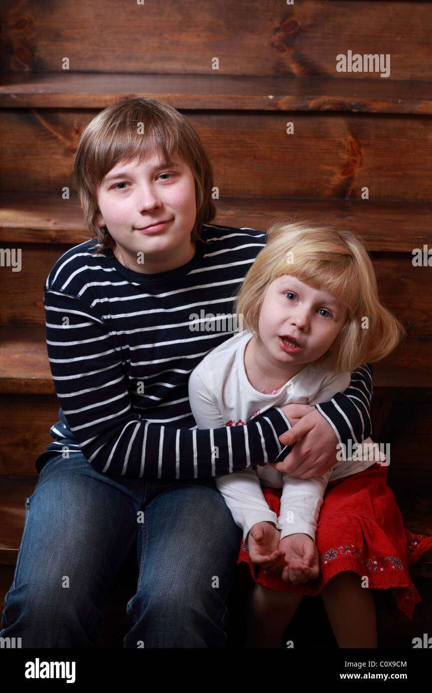 Brother and sister sitting on the stairs Stock Photo - Alamy