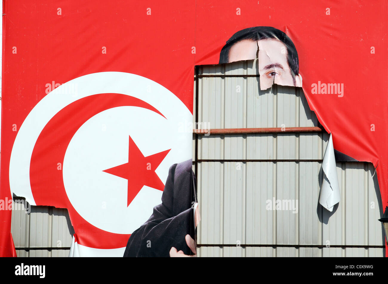 Defaced billboard portrait of ousted strongman Ben Ali during the ...