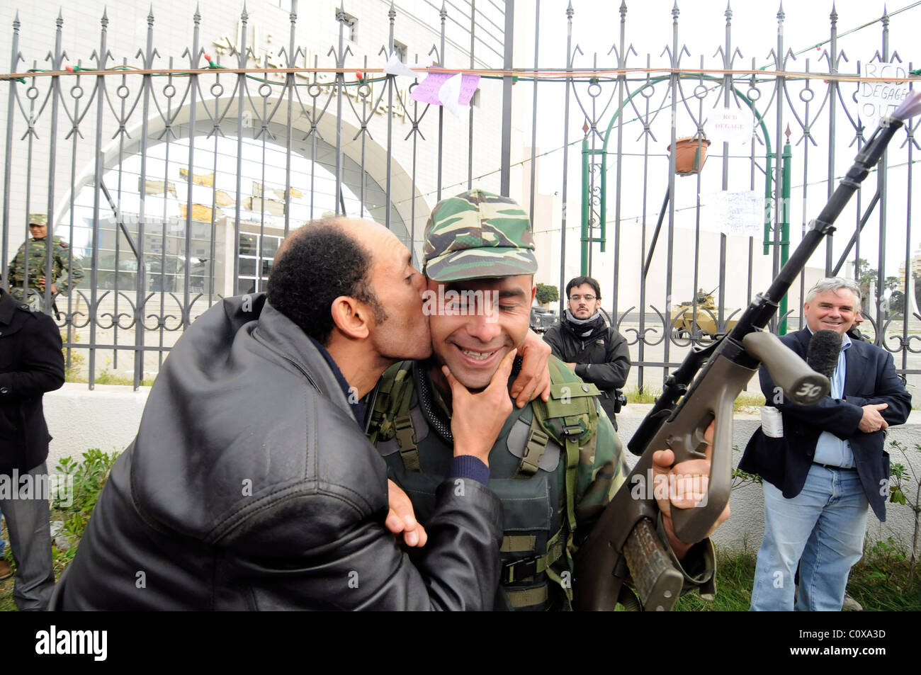 A Tunisian protester kissing a soldier during the Jasmine Revolution in ...