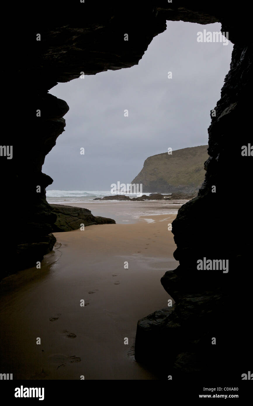 Winter surf seen through rock arch on Watergate Bay, Newquay, Cornwall ...
