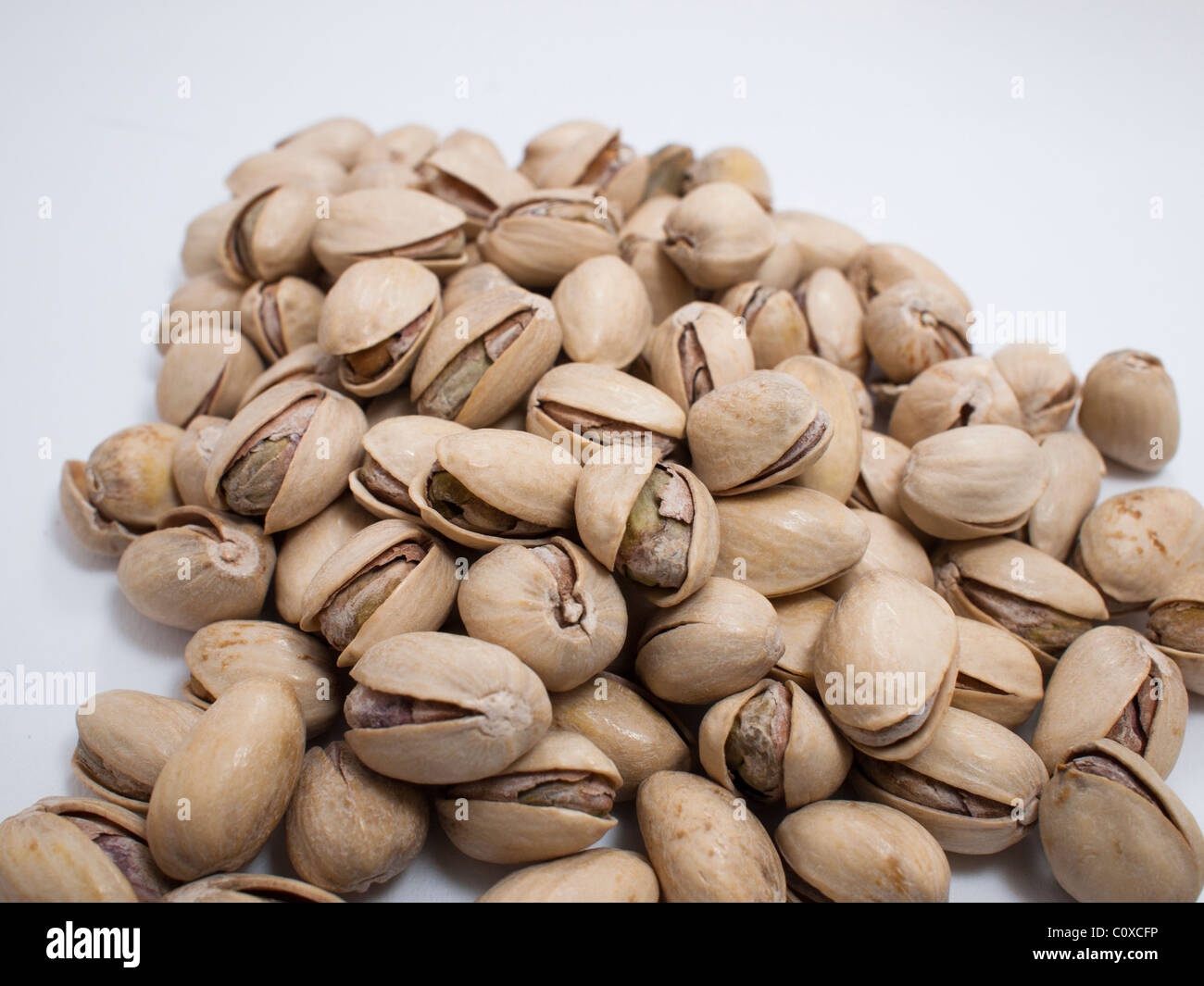 A Commercially prepared pistachios in shells close-up in a white ...