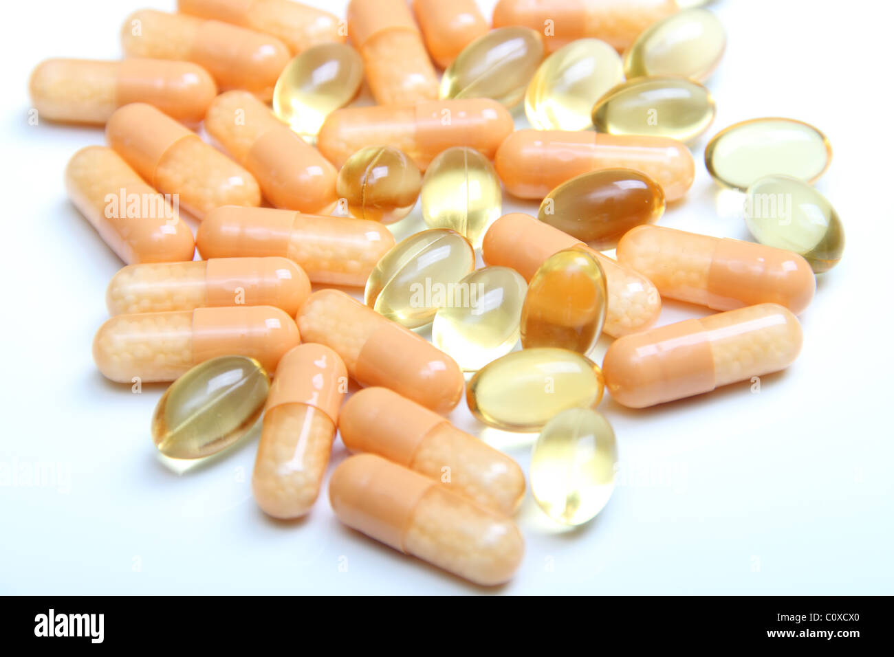 medicine capsules scattered on a white background Stock Photo - Alamy