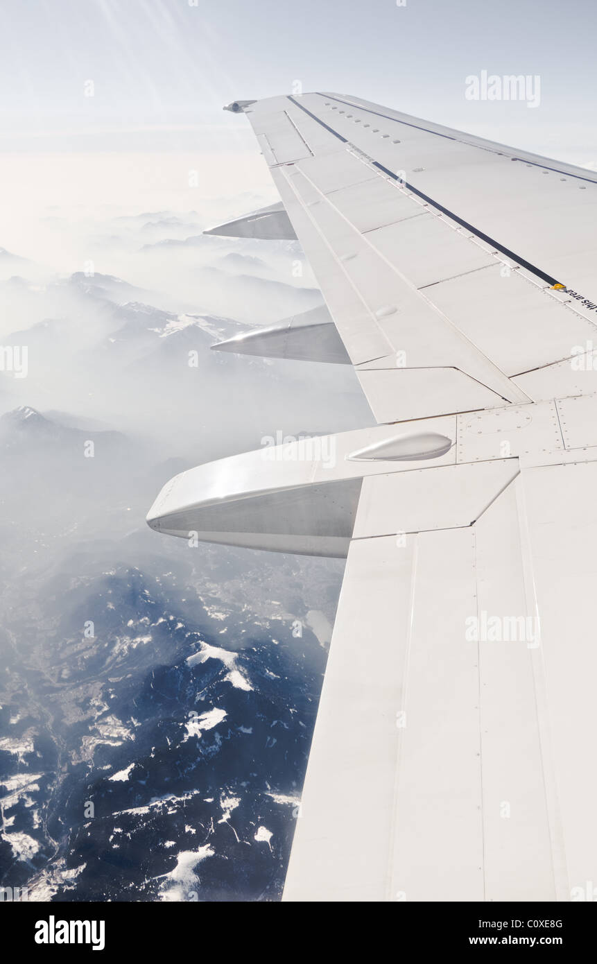 airplane wing flying over snow capped mountains Stock Photo - Alamy
