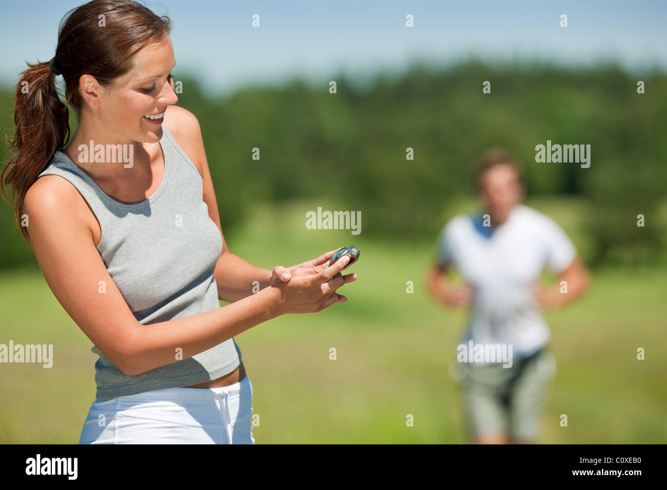 Young couple jogging outdoors in spring nature on sunny day Stock Photo ...