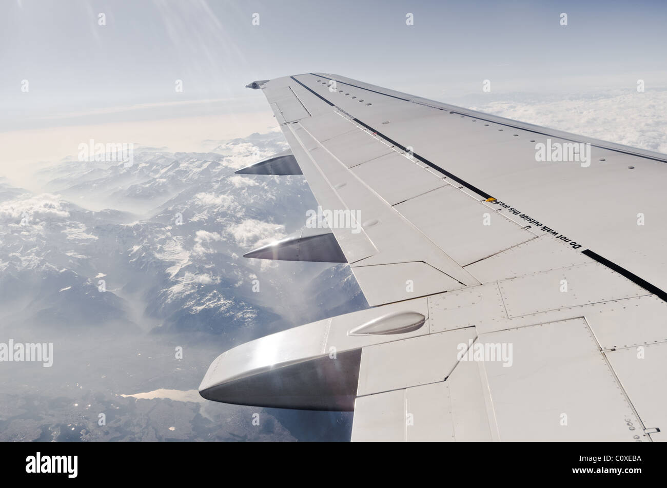 airplane wing flying over snow capped mountains Stock Photo - Alamy