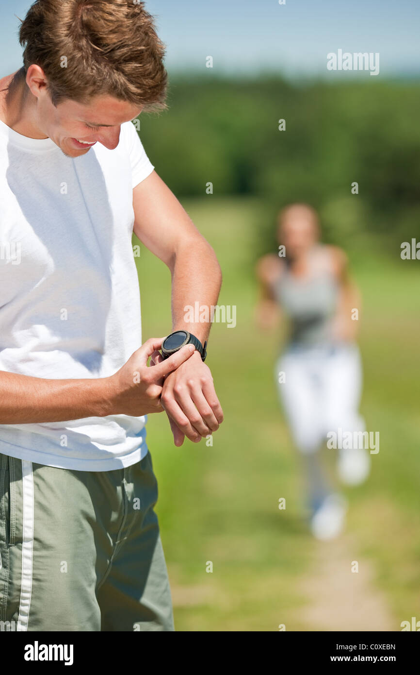 Young woman jogging stopwatch in hi-res stock photography and images ...