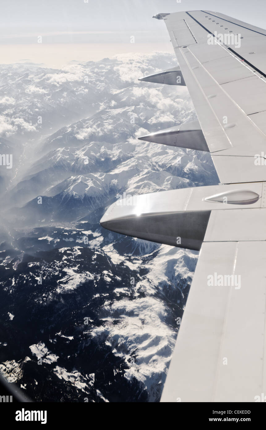 airplane wing flying over snow capped mountains Stock Photo - Alamy