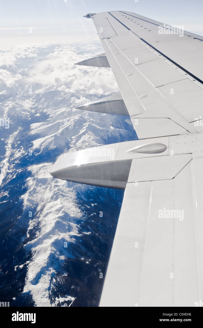 airplane wing flying over snow capped mountains Stock Photo - Alamy