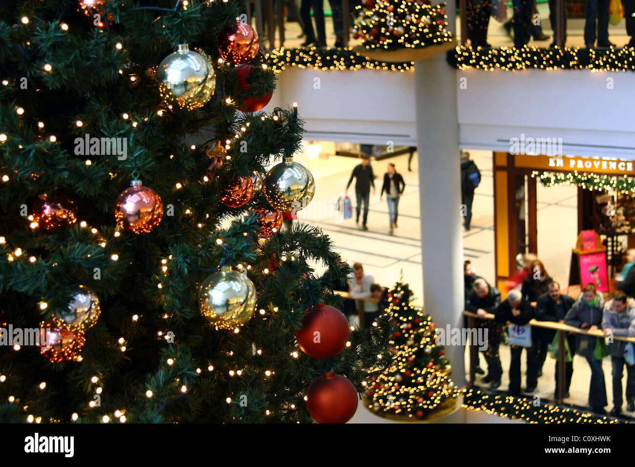 Multilevel shopping mall interior decorated with christmas trees Stock ...