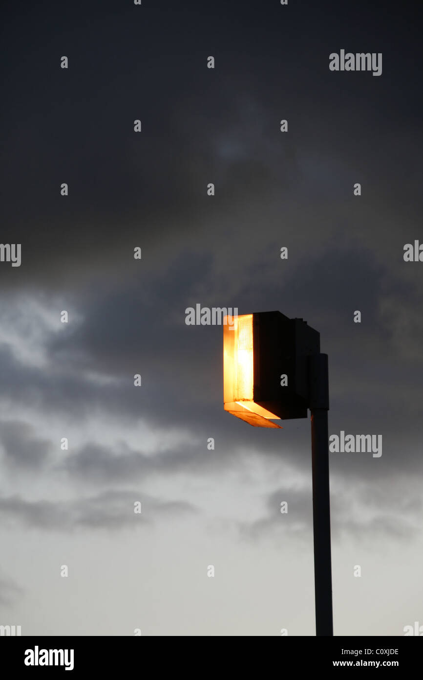one lit light bulb outdoors in dark grey sky Stock Photo - Alamy