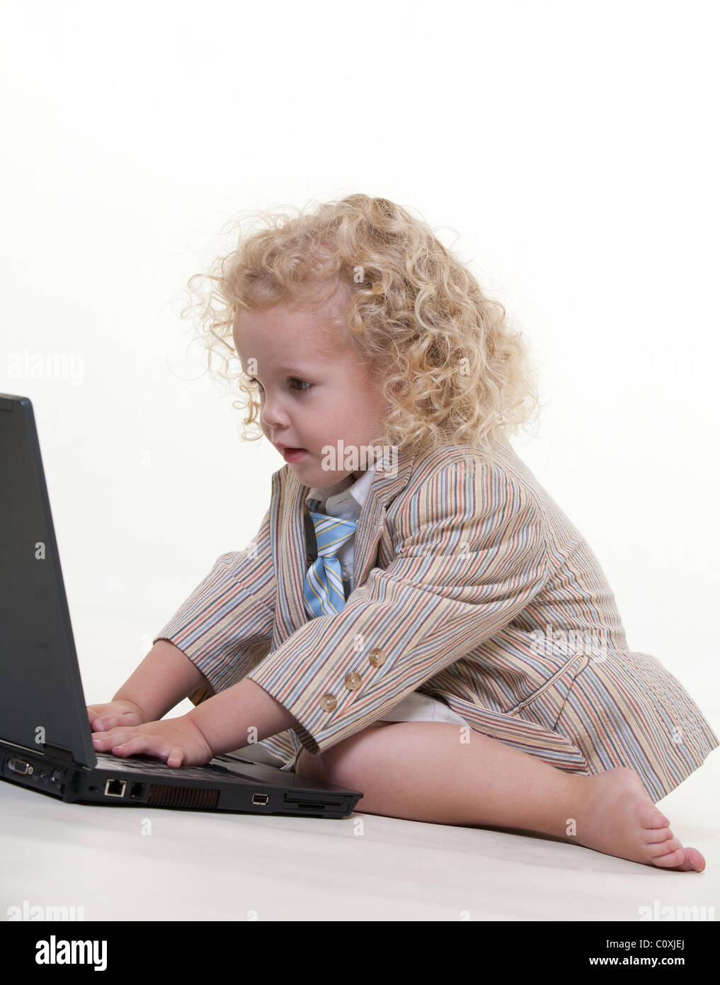 Cute little jewish boy playing with laptop Stock Photo - Alamy