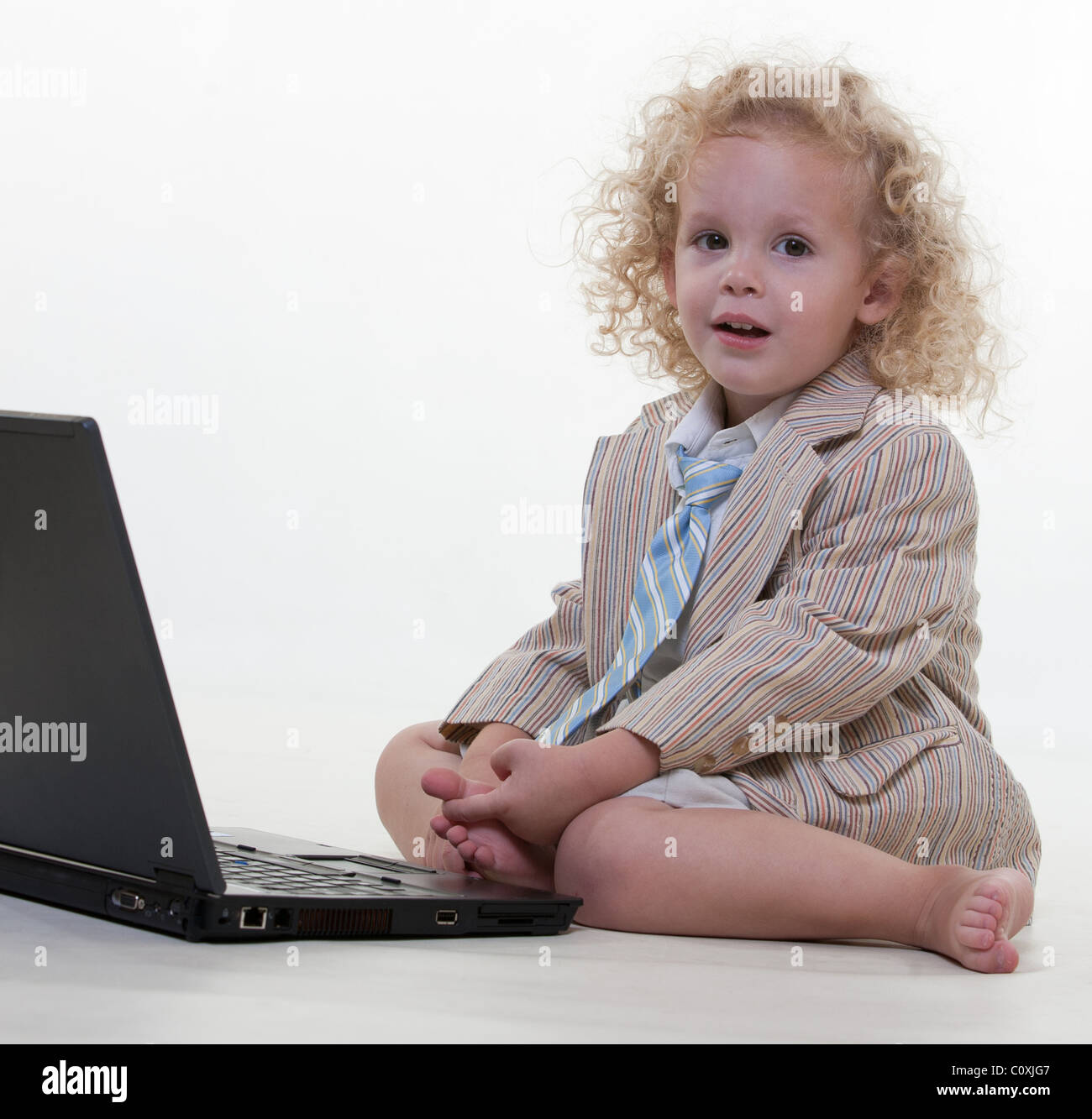 Cute little jewish boy playing with laptop Stock Photo - Alamy