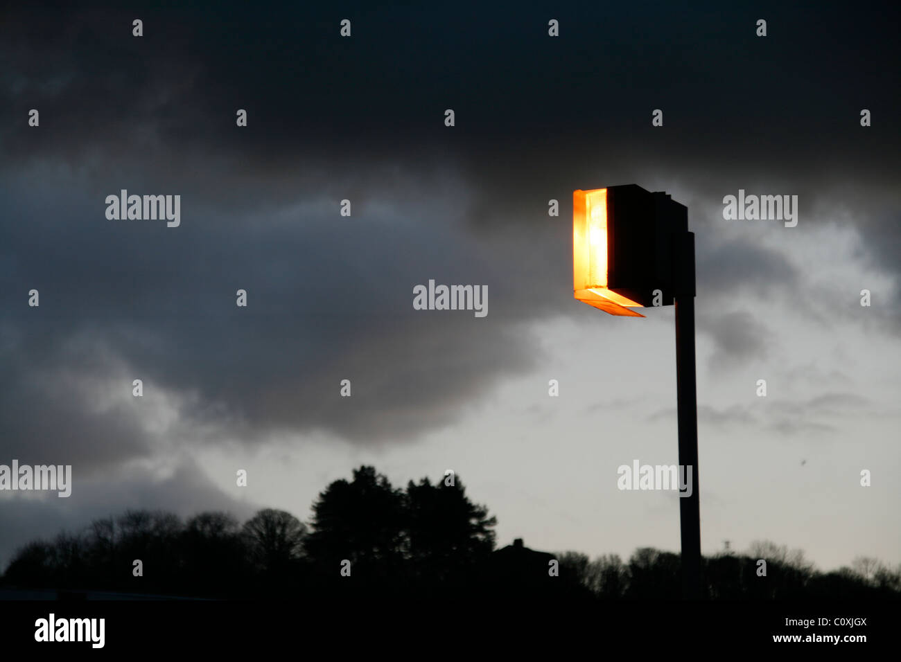 one lit light bulb outdoors in dark grey sky Stock Photo - Alamy