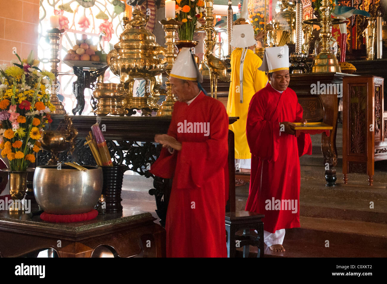 Cao dai high priests getting ready for ceremony in the Cao Dai Tay Ninh ...