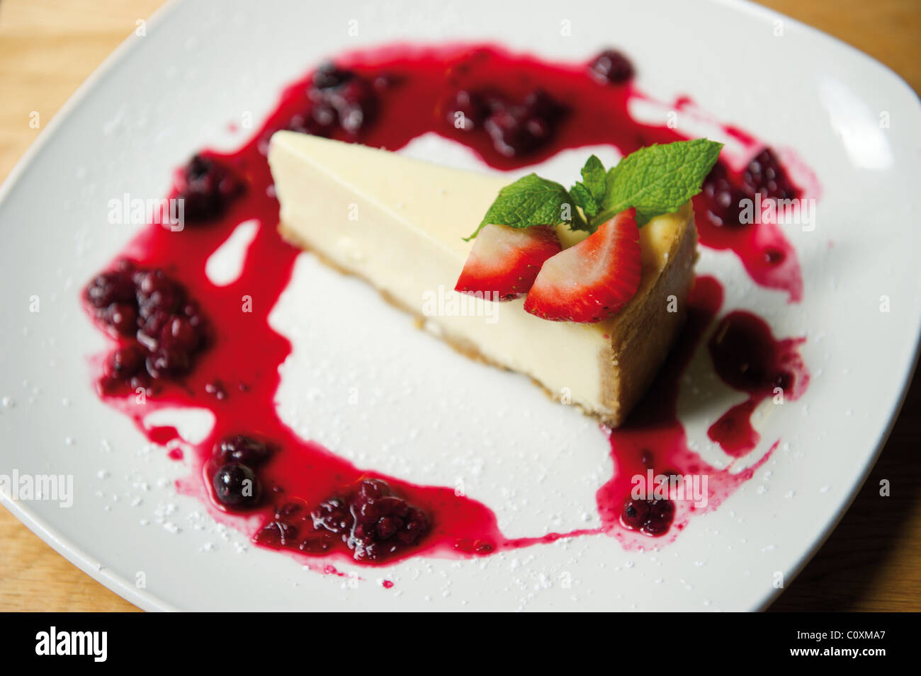 Baked vanilla cheescake with summer berry compote desert Stock Photo ...