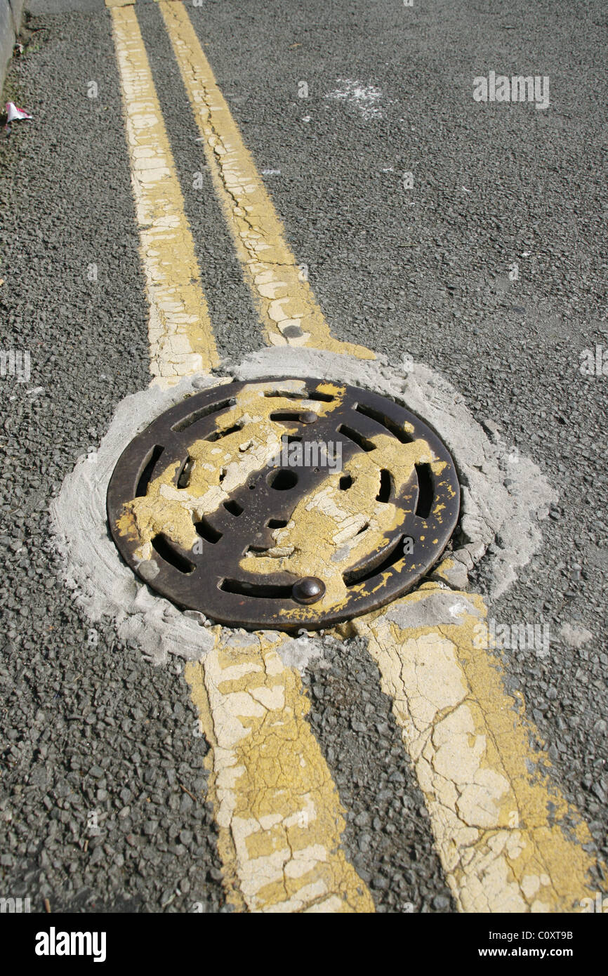 manhole and double yellow lines on street road in wales great britain ...