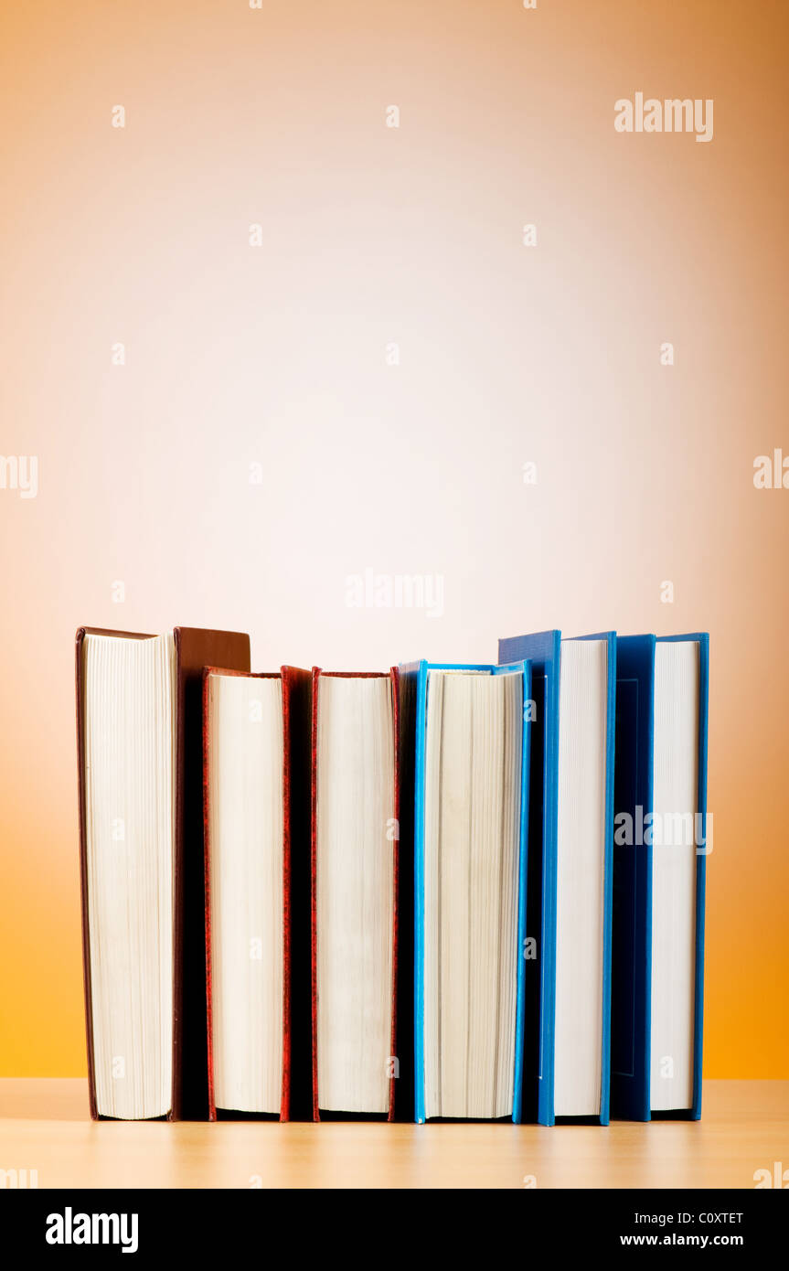 Stack of text books against gradient background Stock Photo - Alamy