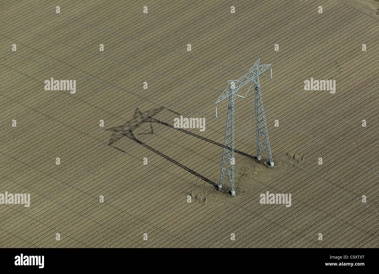 aerial view above tower electrical transmission lines crossing farm ...
